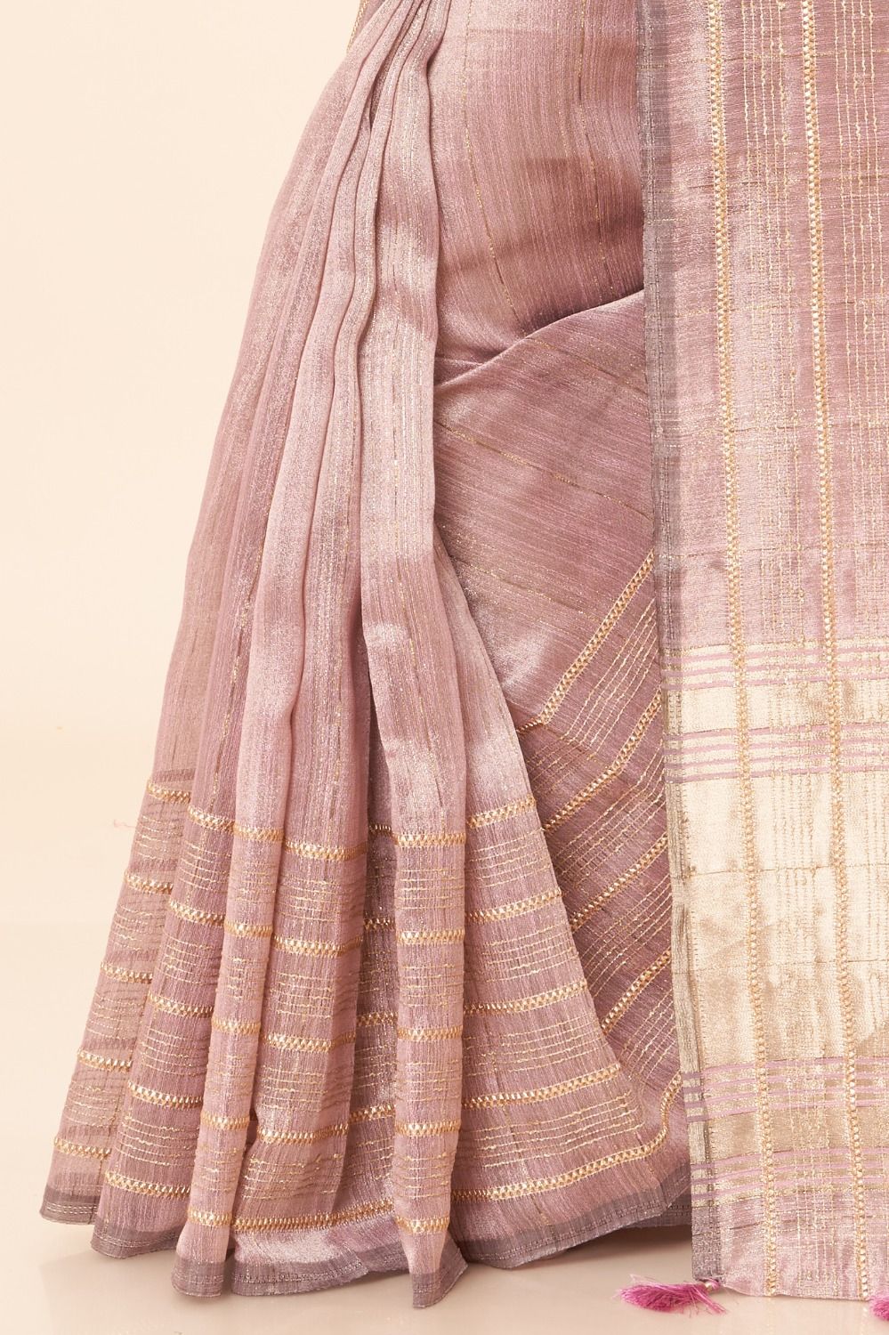 Elegant light pink saree with a subtle sheen and intricate golden ...